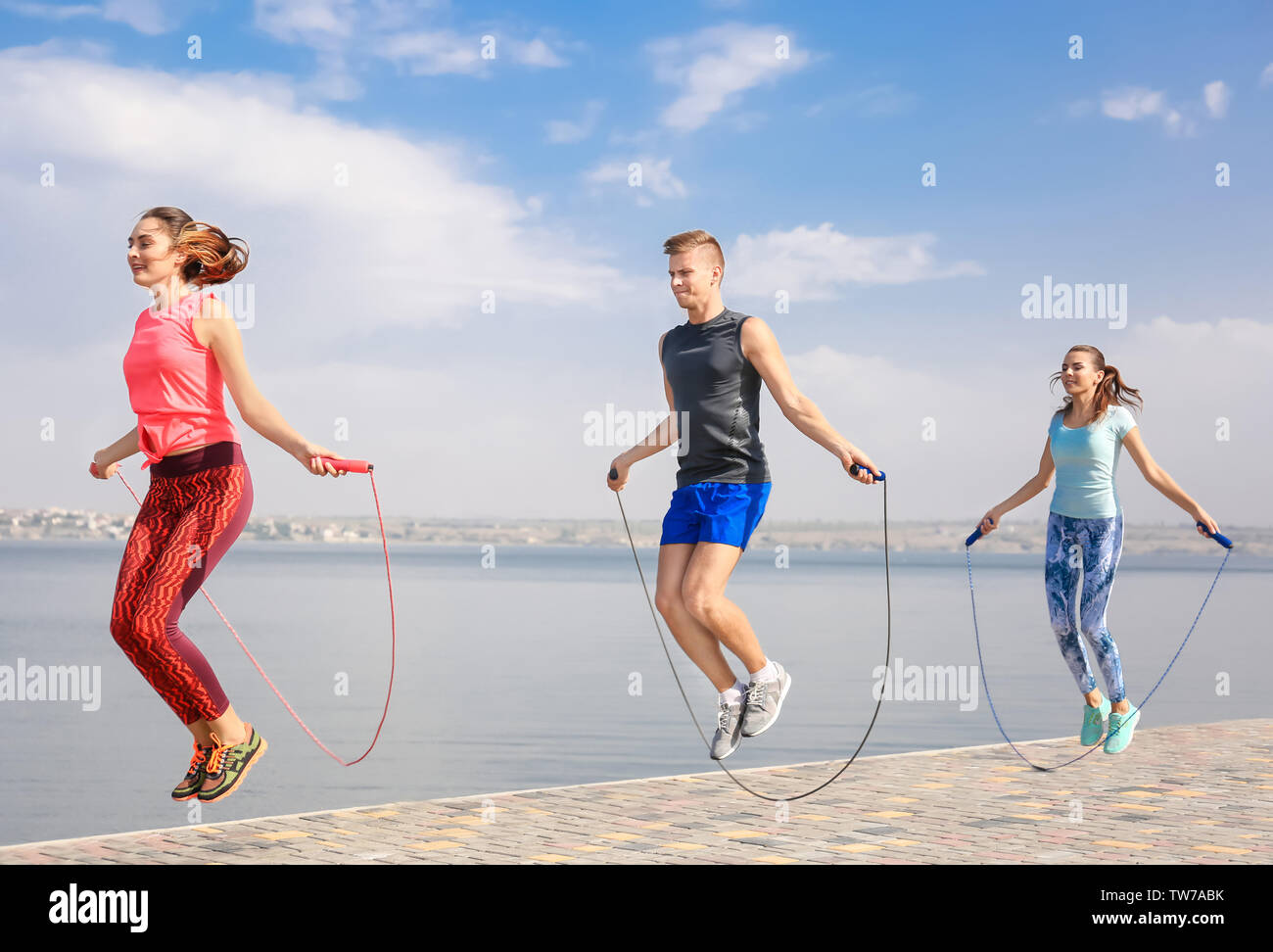 Young people with jumping ropes on quay Stock Photo - Alamy