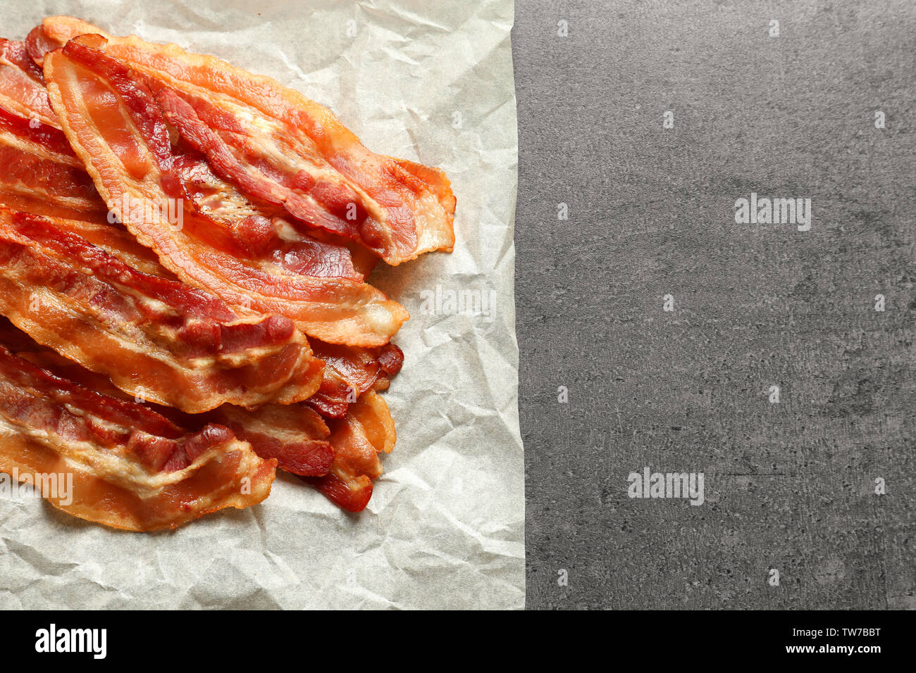 Parchment with cooked bacon rashers on table Stock Photo - Alamy