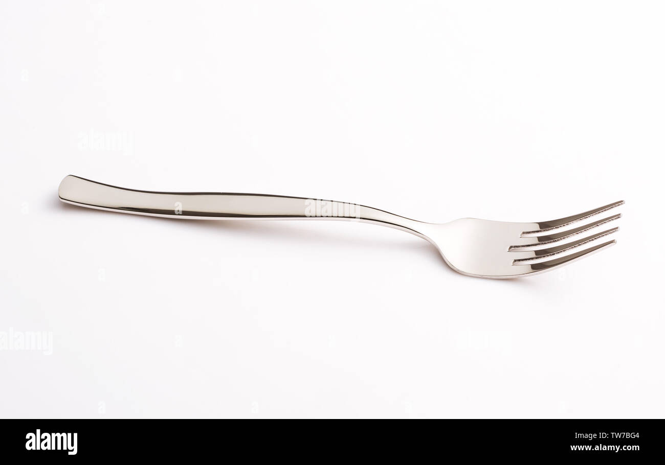 A silver fork on a white background Stock Photo - Alamy