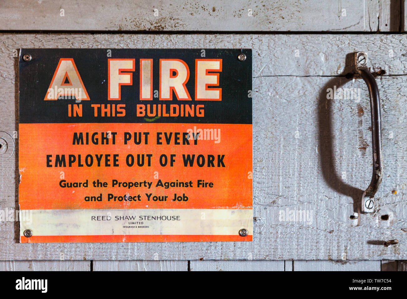 Fire danger warning sign inside a wooden heritage shipbuilding shed in ...