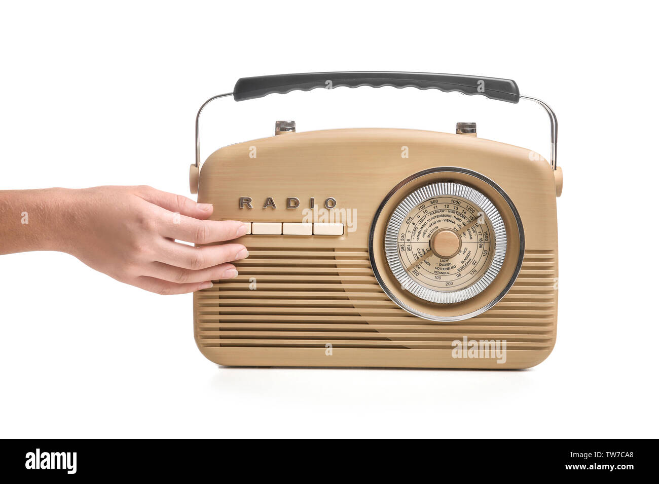 Hand of young woman with retro radio receiver on white background Stock ...