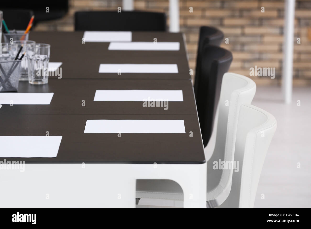 Big table with sheets of paper, indoors Stock Photo - Alamy