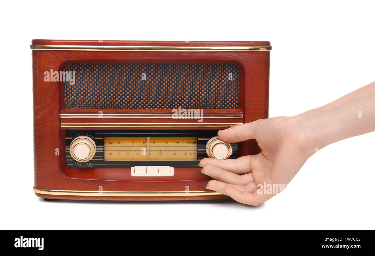 Hand of young woman with retro radio receiver on white background Stock ...