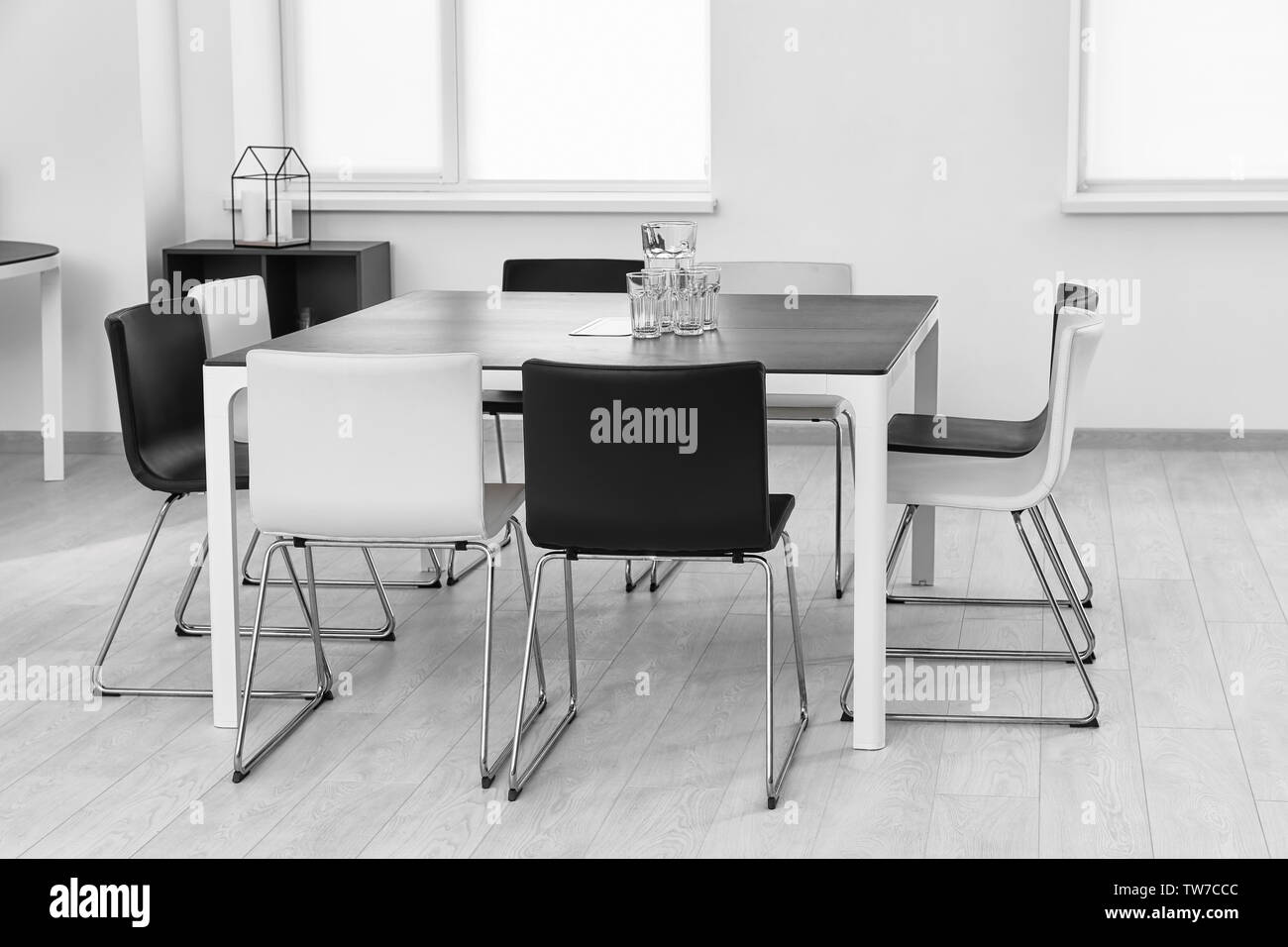 Modern room interior with big table and chairs Stock Photo - Alamy