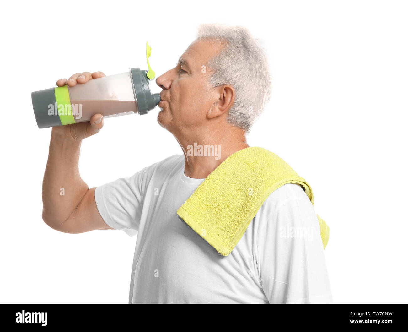Sporty senior man drinking protein shake on white background Stock ...