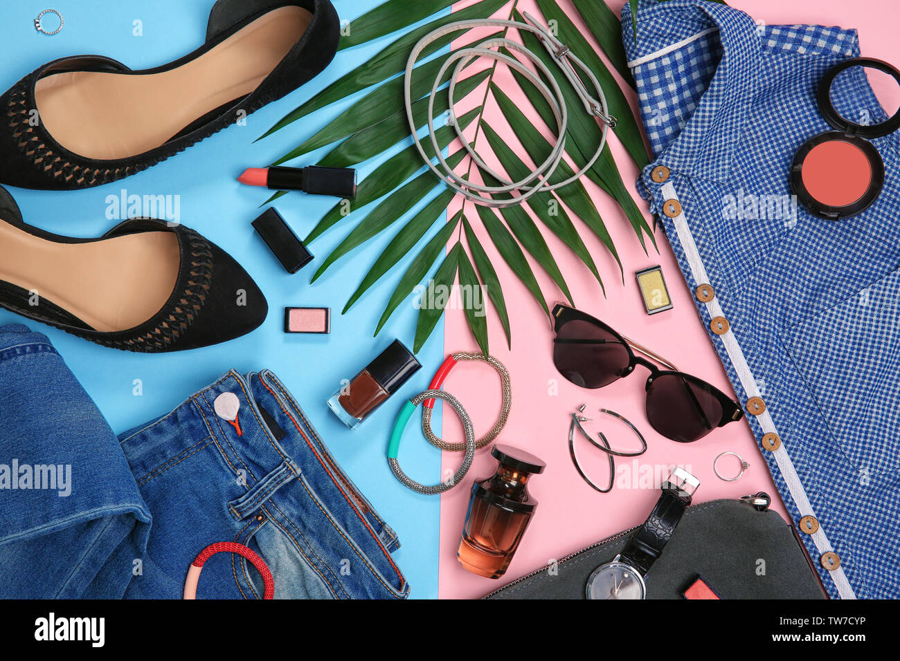 Composition with trendy clothes and tropical leaves on color background ...