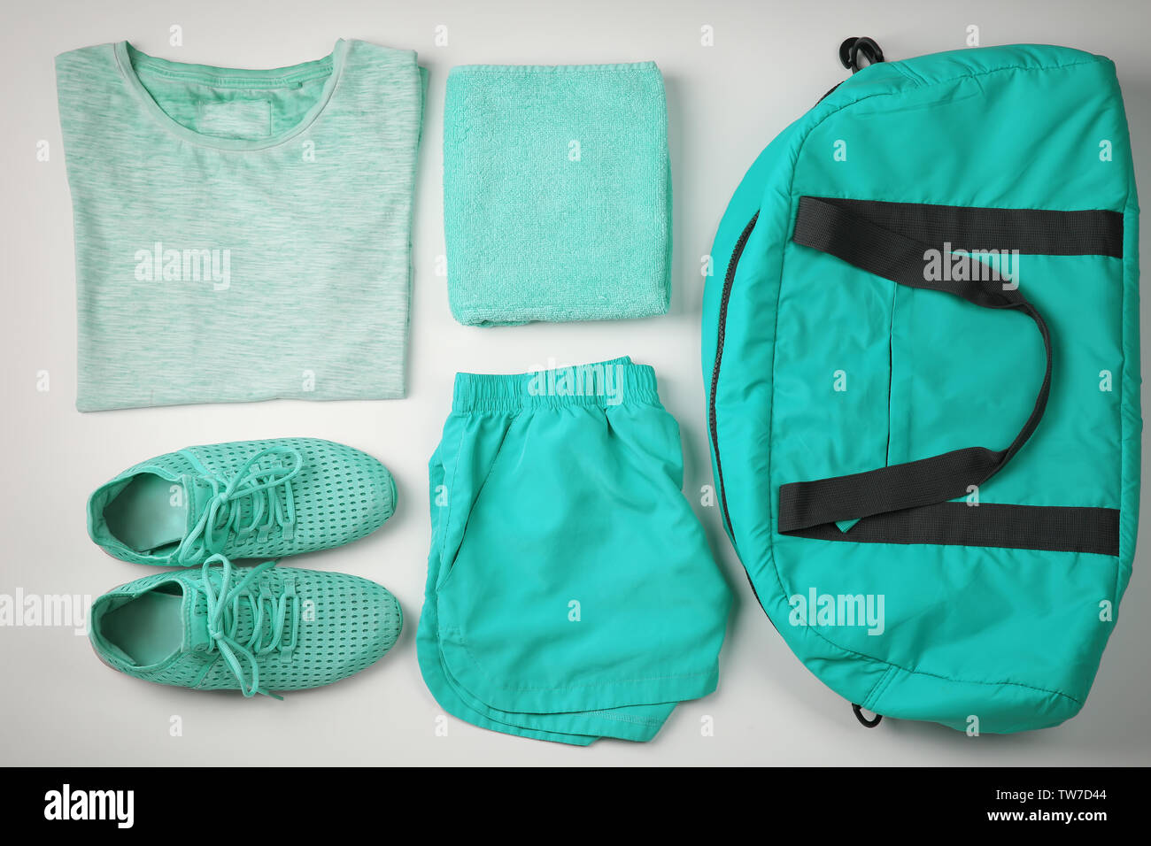Composition with mint color clothes on light background Stock Photo - Alamy