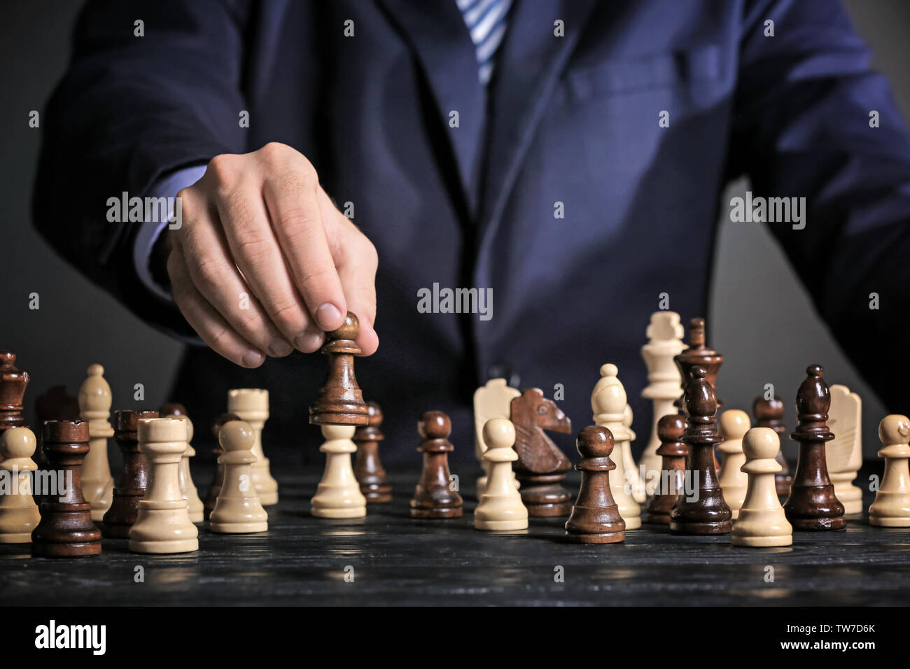 Young man with chess at table Stock Photo - Alamy