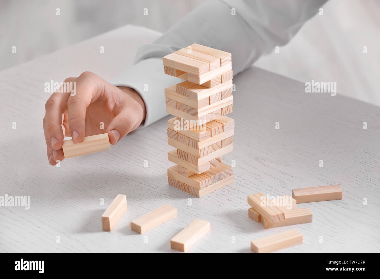 Young man with jenga at table Stock Photo - Alamy