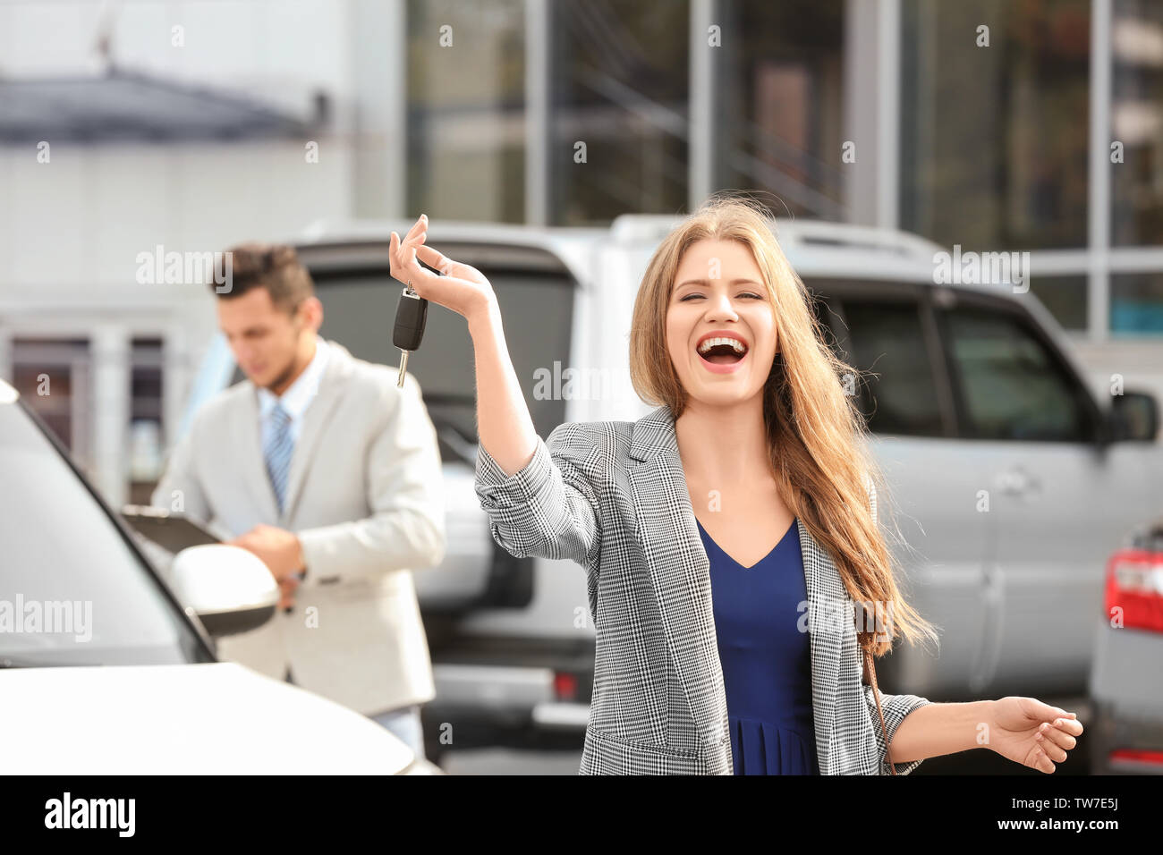 Happy customer with key near new car outdoors Stock Photo - Alamy