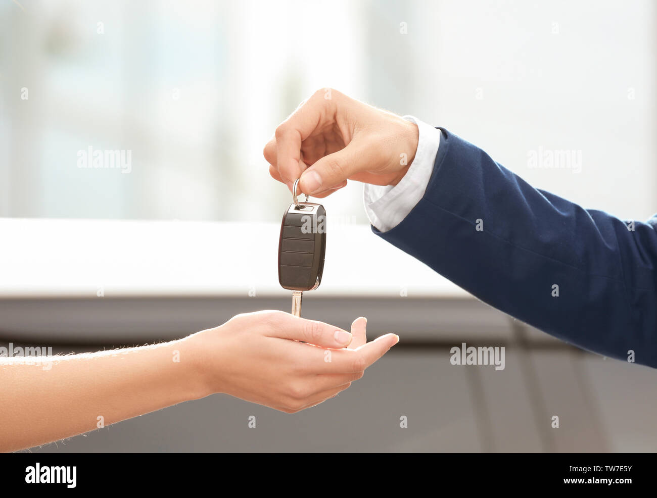 Salesman giving car key to customer outdoors Stock Photo - Alamy