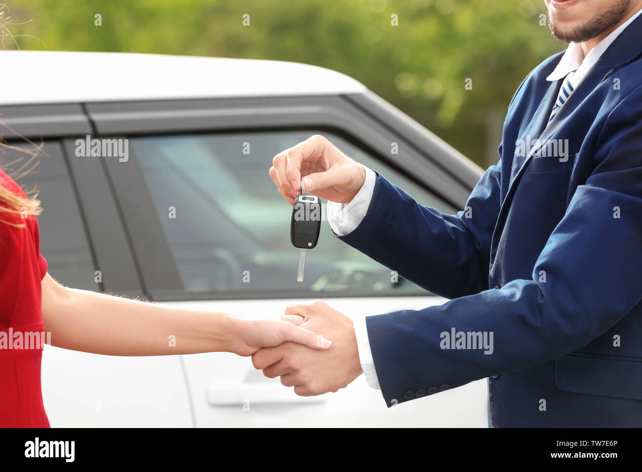 Salesman giving car key to customer outdoors Stock Photo - Alamy