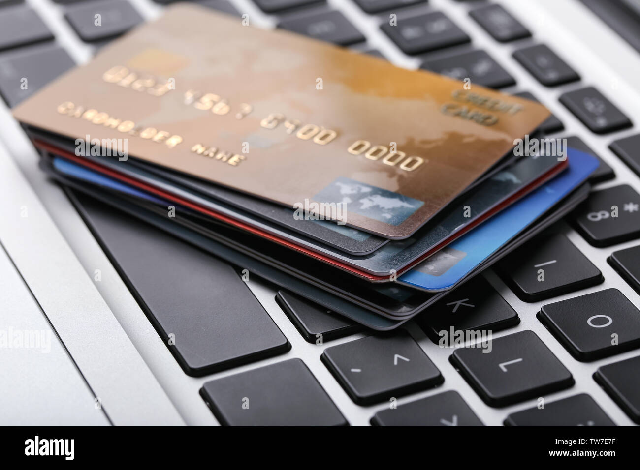 Credit cards on laptop keyboard, close up Stock Photo - Alamy