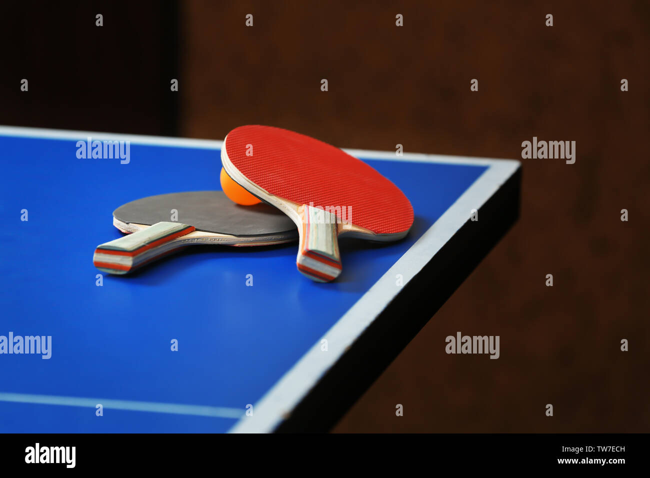 Two ping pong rackets and ball on table Stock Photo - Alamy