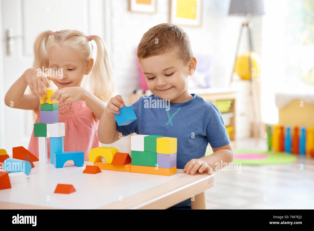 Cute little children playing with blocks at home Stock Photo - Alamy