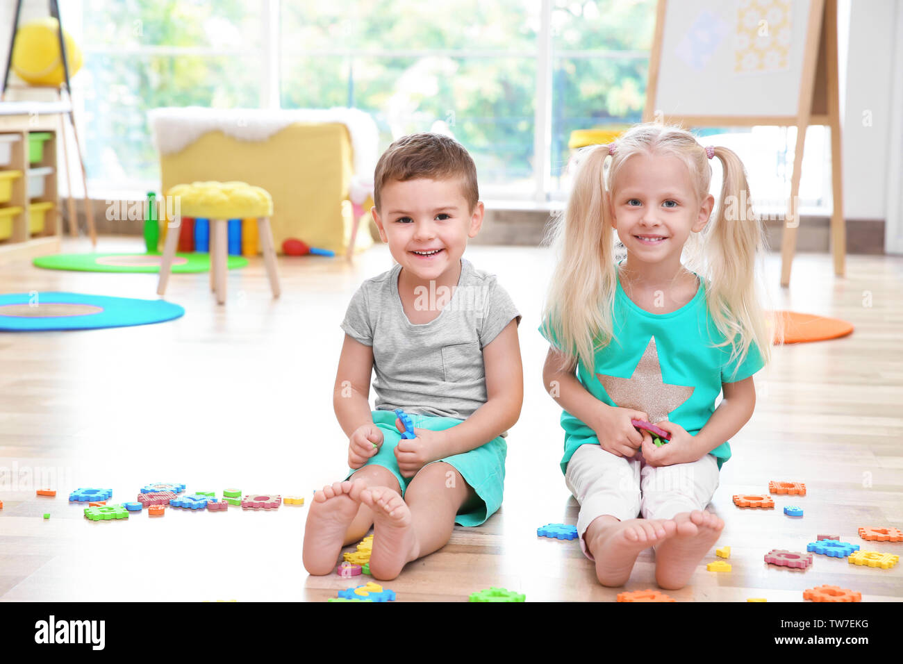 Cute little children playing with math puzzle at home Stock Photo - Alamy