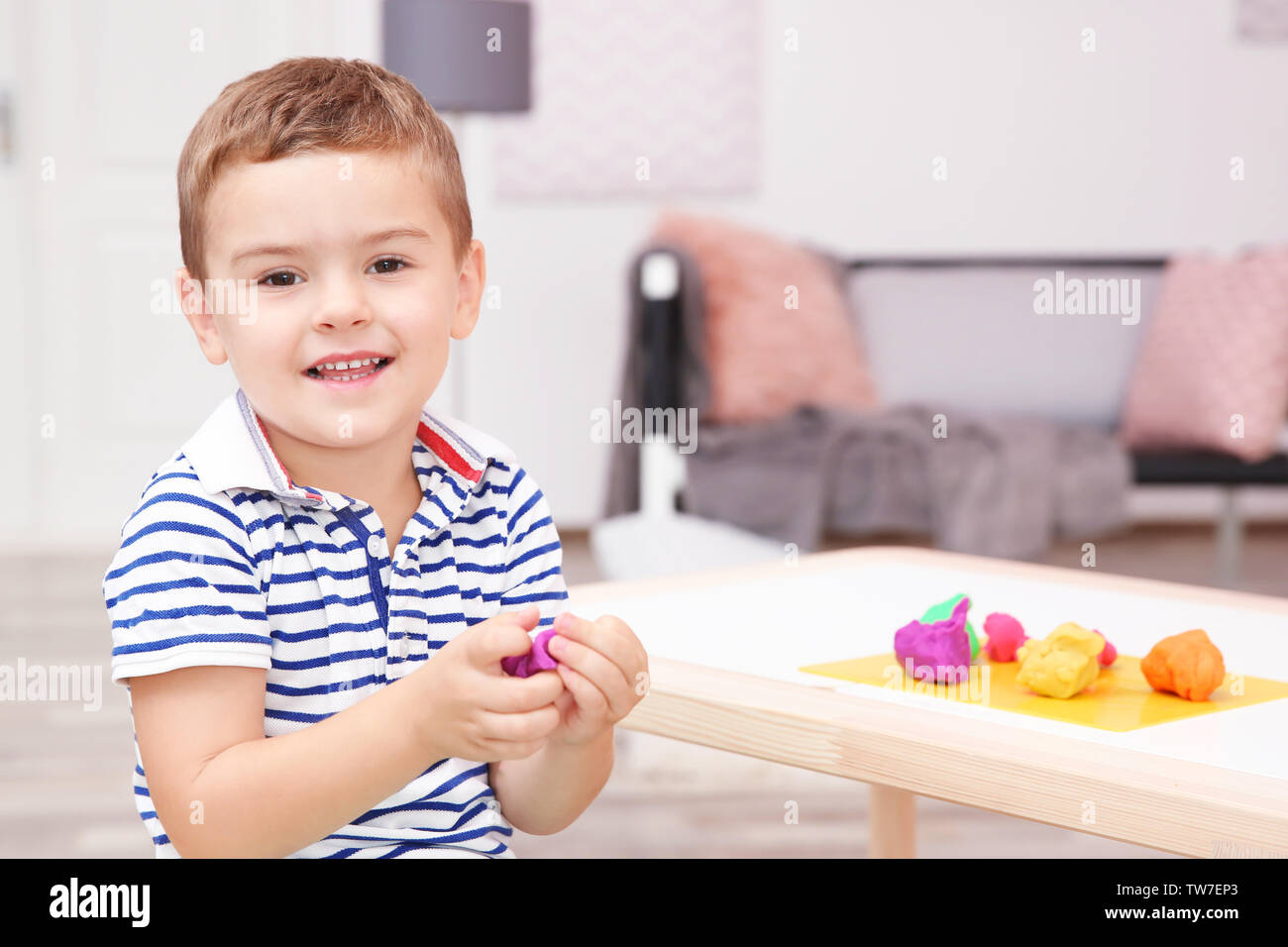 Cute little boy modeling from playdough at home Stock Photo - Alamy