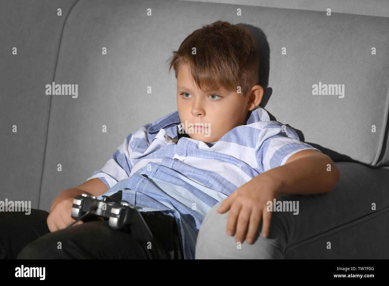 Fat kid playing video game hi-res stock photography and images - Alamy