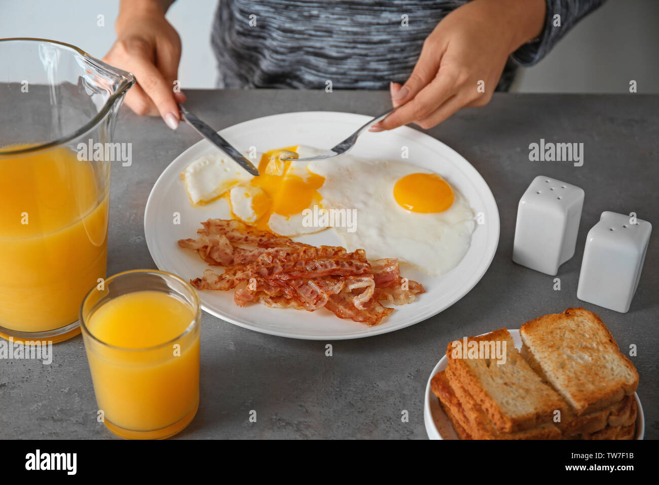 Woman bacon eggs table hi-res stock photography and images - Alamy
