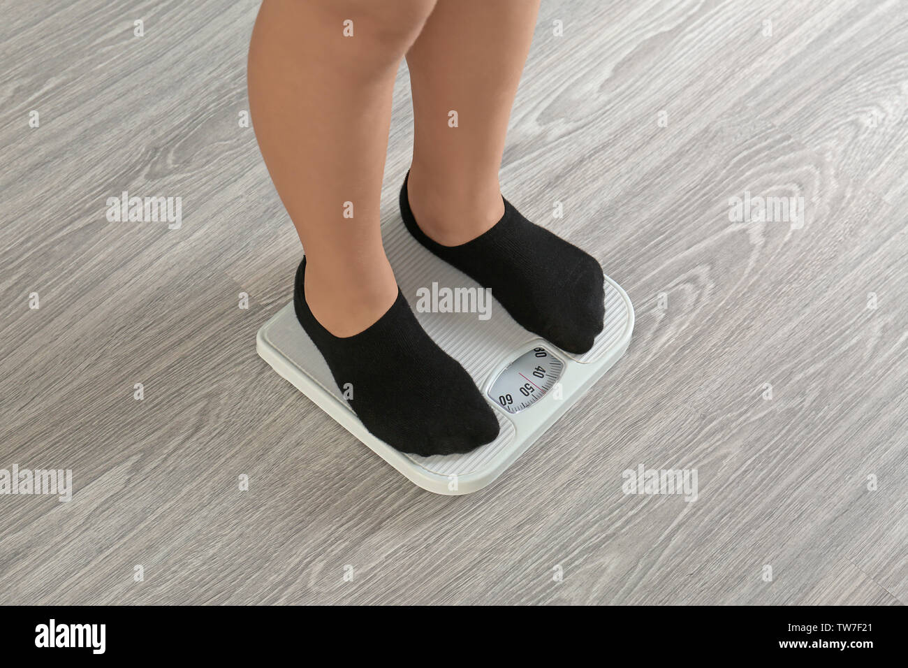 Fat child boy scales hi-res stock photography and images - Alamy