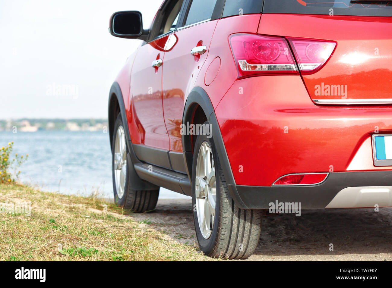 Modern car on river bank Stock Photo - Alamy