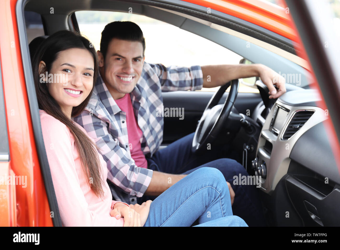 Young couple sitting in modern car Stock Photo - Alamy