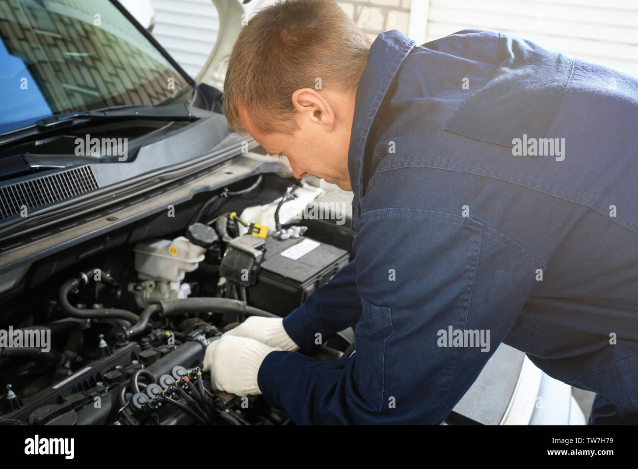 Auto mechanic repairing car outdoors Stock Photo - Alamy