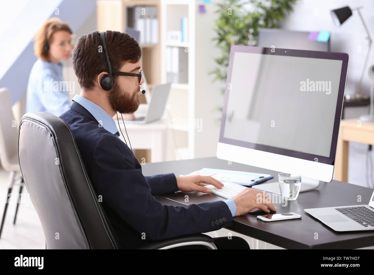 Manager working with computer in office Stock Photo - Alamy