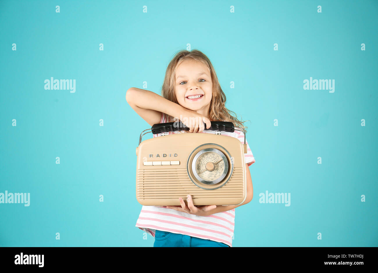 Little girl with radio against color background Stock Photo - Alamy