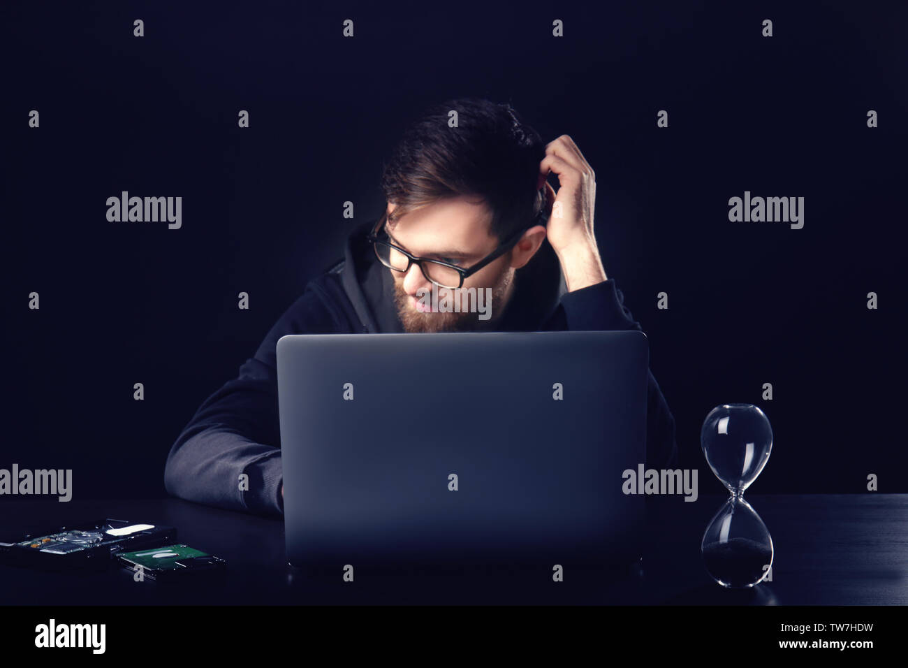 Man hacking server against dark background Stock Photo - Alamy