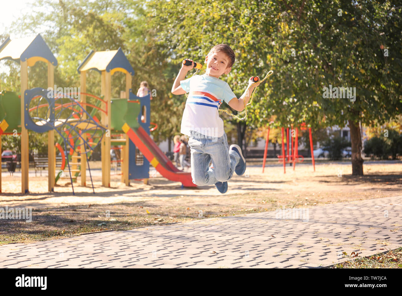 Cute boy skipping rope, outdoors Stock Photo - Alamy