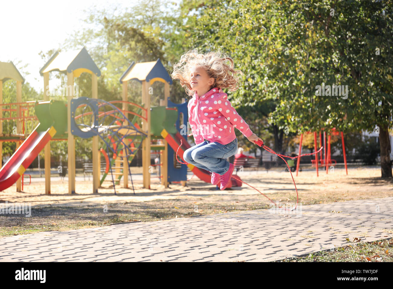 Cute girl skipping rope, outdoors Stock Photo - Alamy