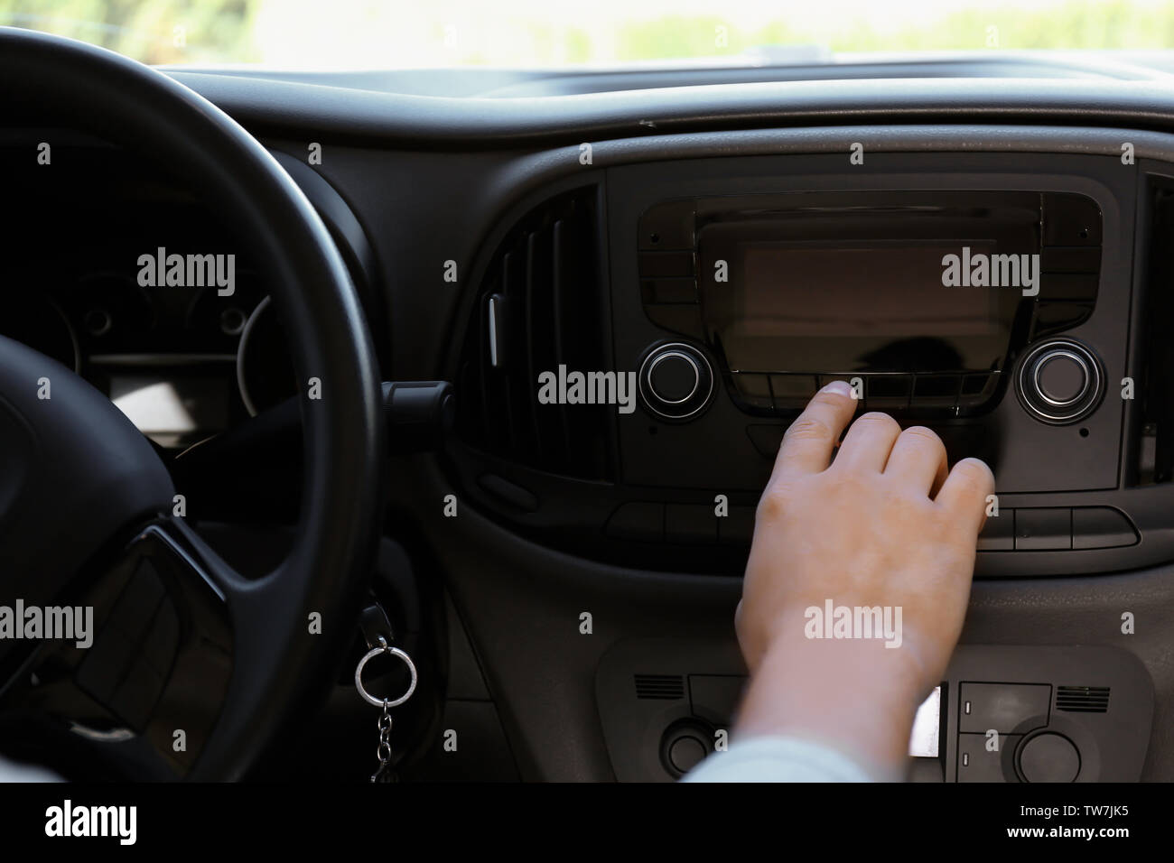 Man tuning radio in car Stock Photo - Alamy