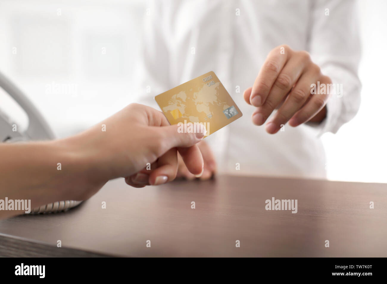 Customer giving credit card to cashier, closeup Stock Photo - Alamy