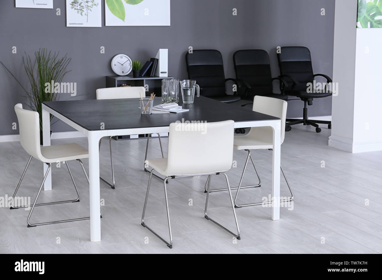 Modern office interior with table and white chairs Stock Photo - Alamy