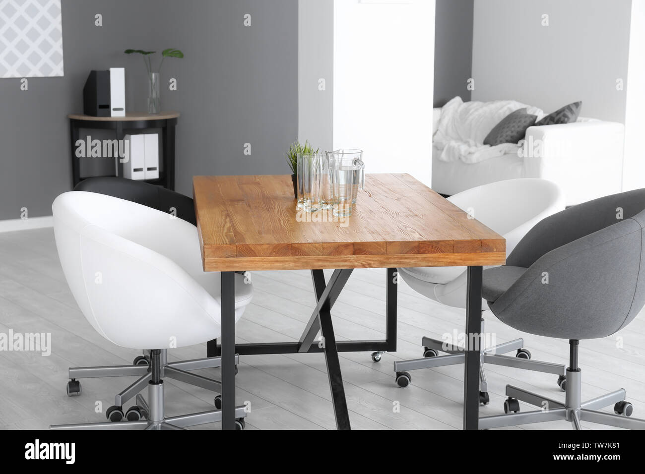 Modern office interior with wooden table and armchairs Stock Photo - Alamy