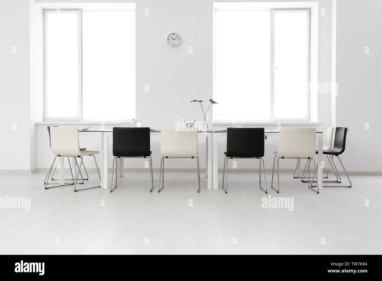 Modern office interior with large table and chairs Stock Photo - Alamy