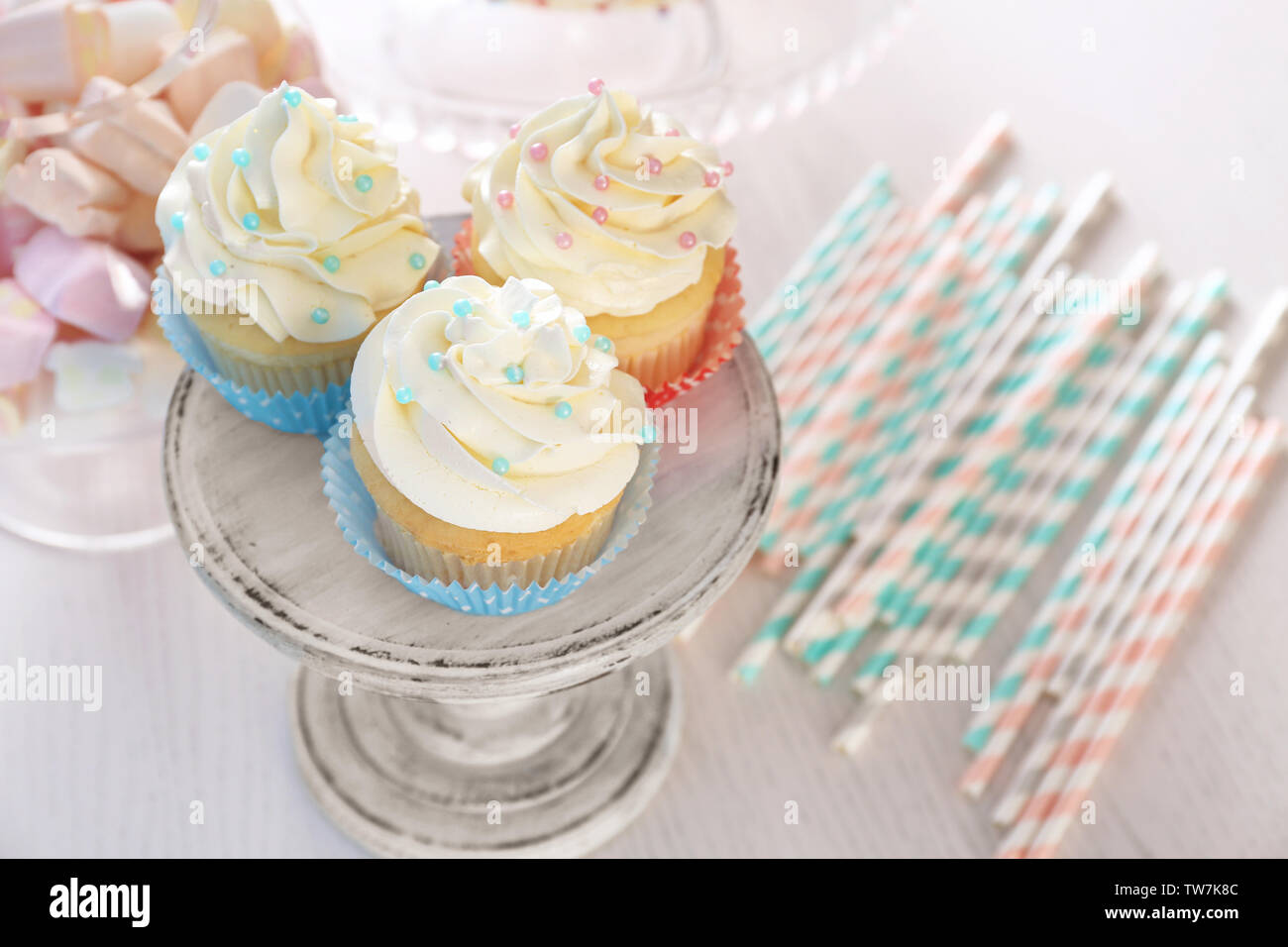 Stand with cupcakes on buffet table Stock Photo - Alamy
