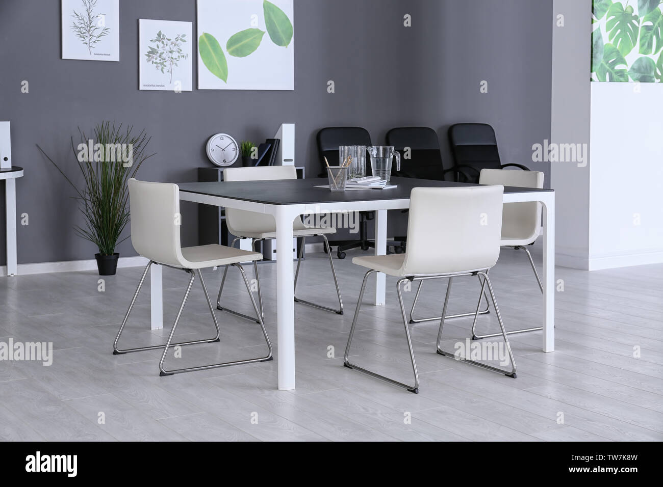 Modern office interior with table and white chairs Stock Photo - Alamy