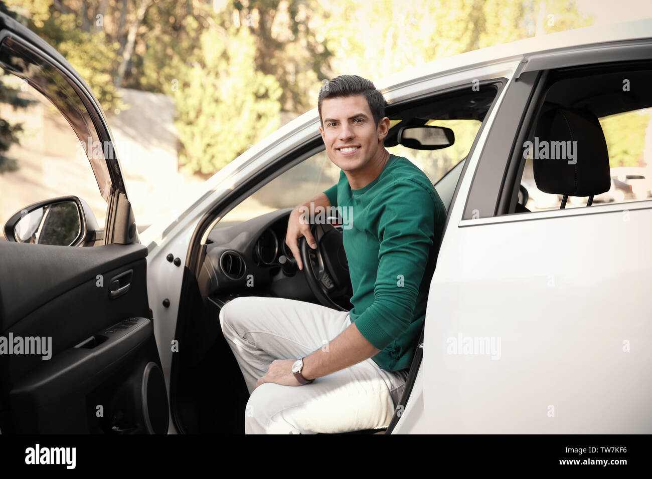 Young man on driver seat of car Stock Photo - Alamy