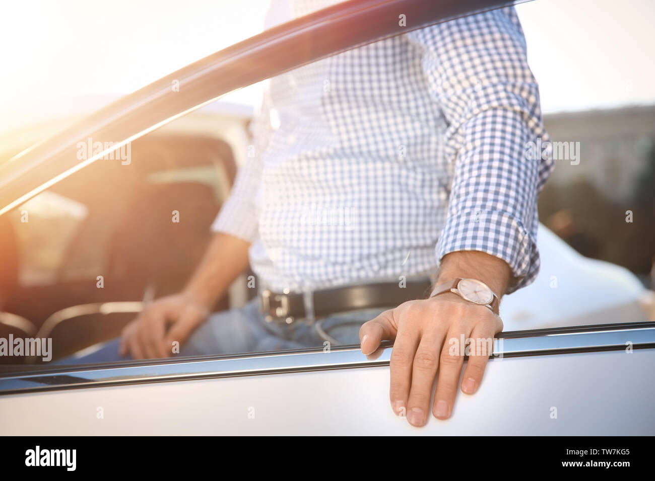 Man standing near car on city street Stock Photo - Alamy