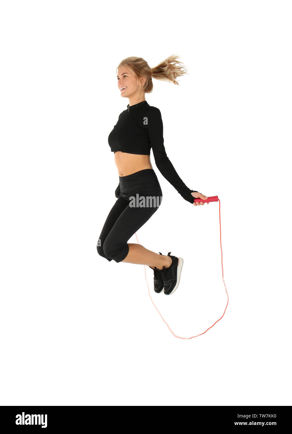 Sporty young woman jumping rope on white background Stock Photo - Alamy