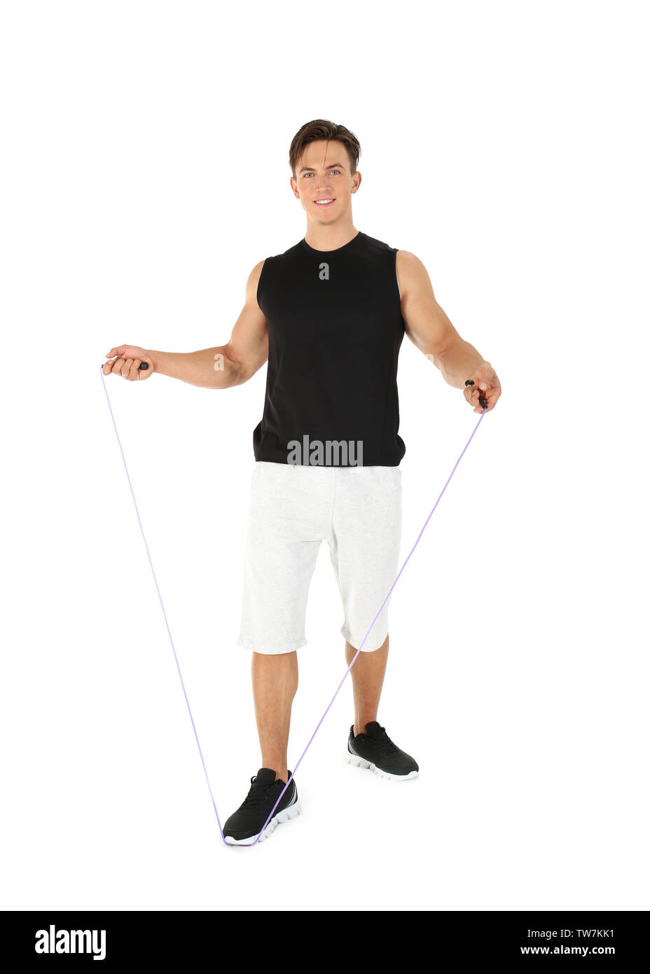 Sporty young man with jumping rope on white background Stock Photo - Alamy