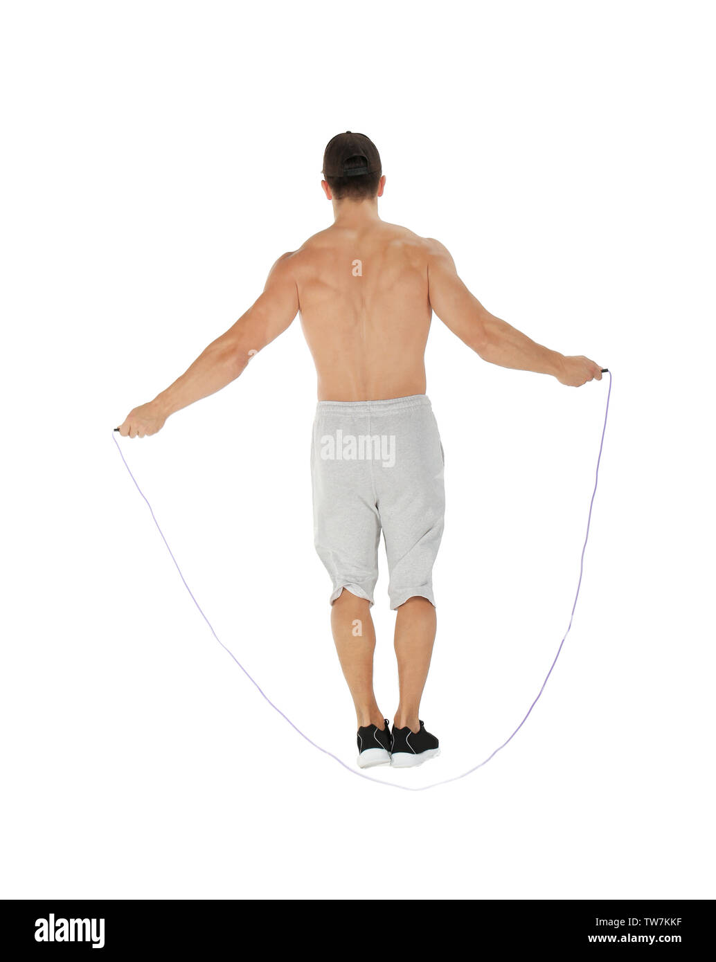 Sporty young man jumping rope on white background Stock Photo - Alamy