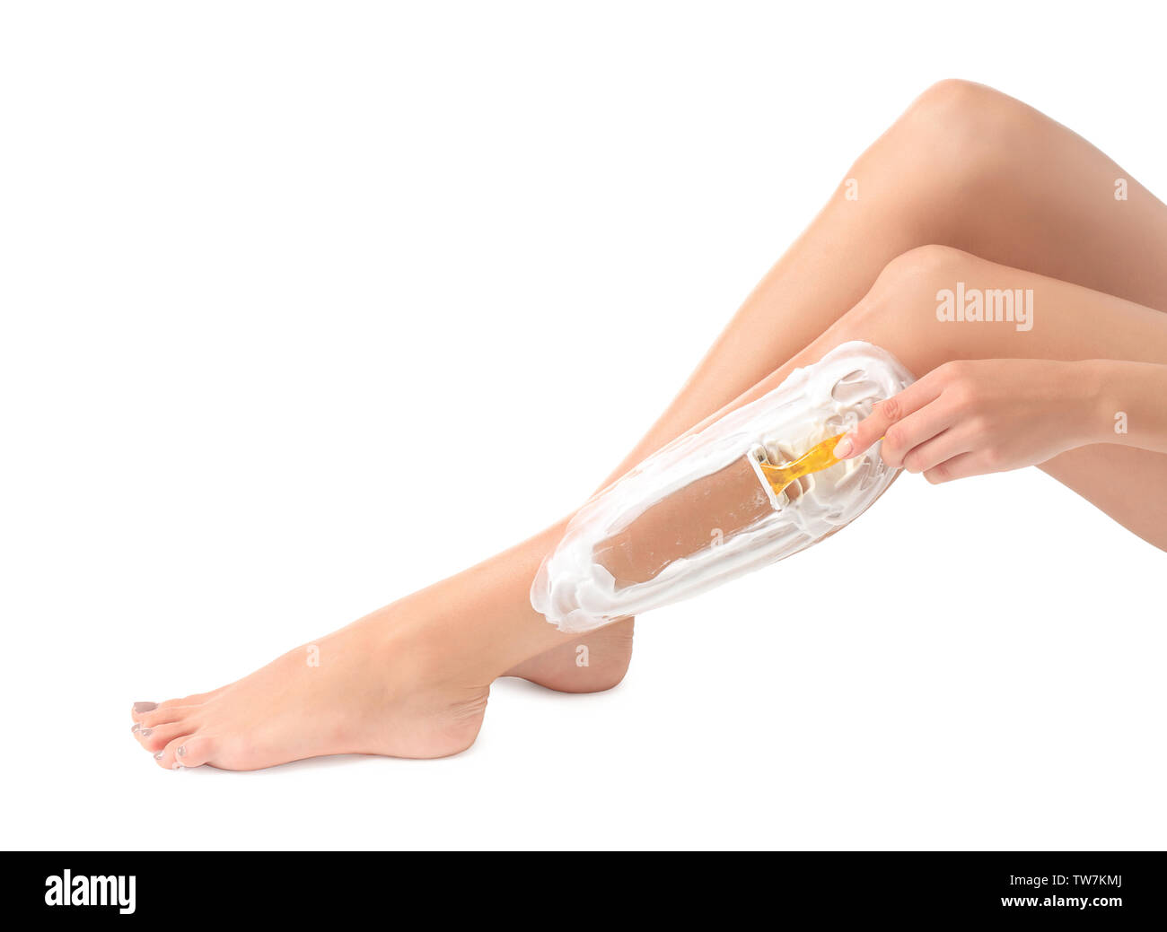 Beautiful woman shaving her legs, isolated on white Stock Photo - Alamy