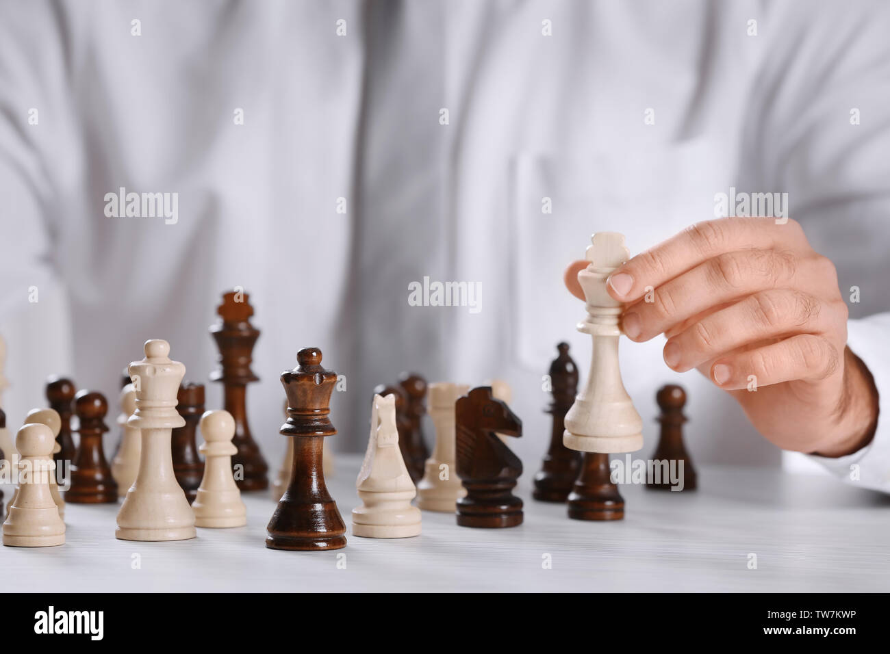 Man playing chess on table. Management concept Stock Photo - Alamy