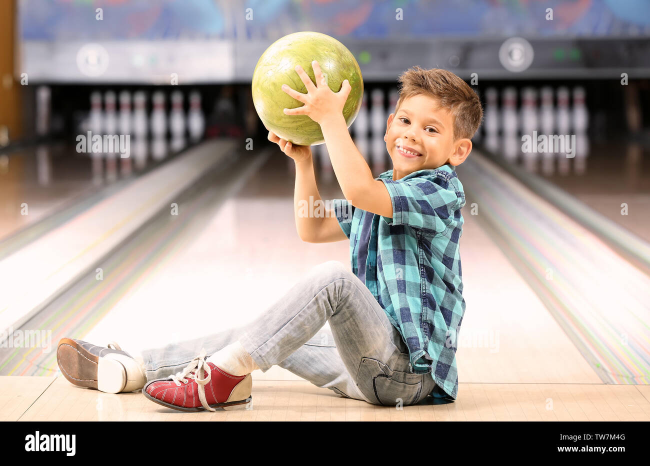 Cute little boy at bowling club Stock Photo - Alamy