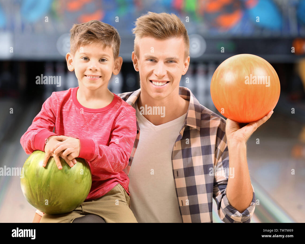 Family having fun in bowling club Stock Photo - Alamy