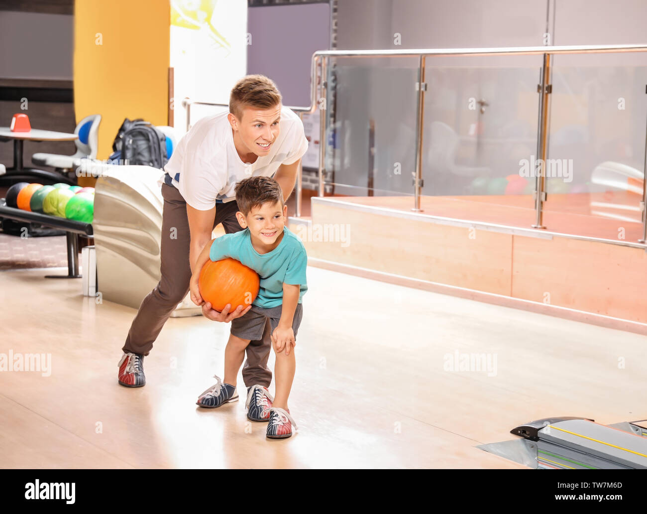 Young father with his son at bowling club Stock Photo - Alamy