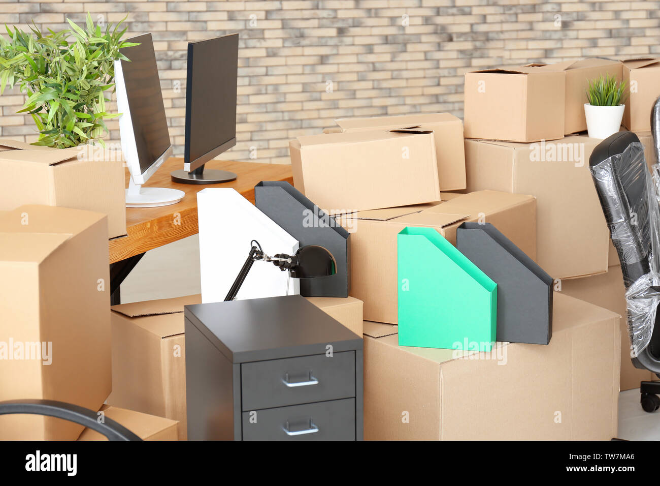 Carton boxes with stuff in room. Office move concept Stock Photo - Alamy